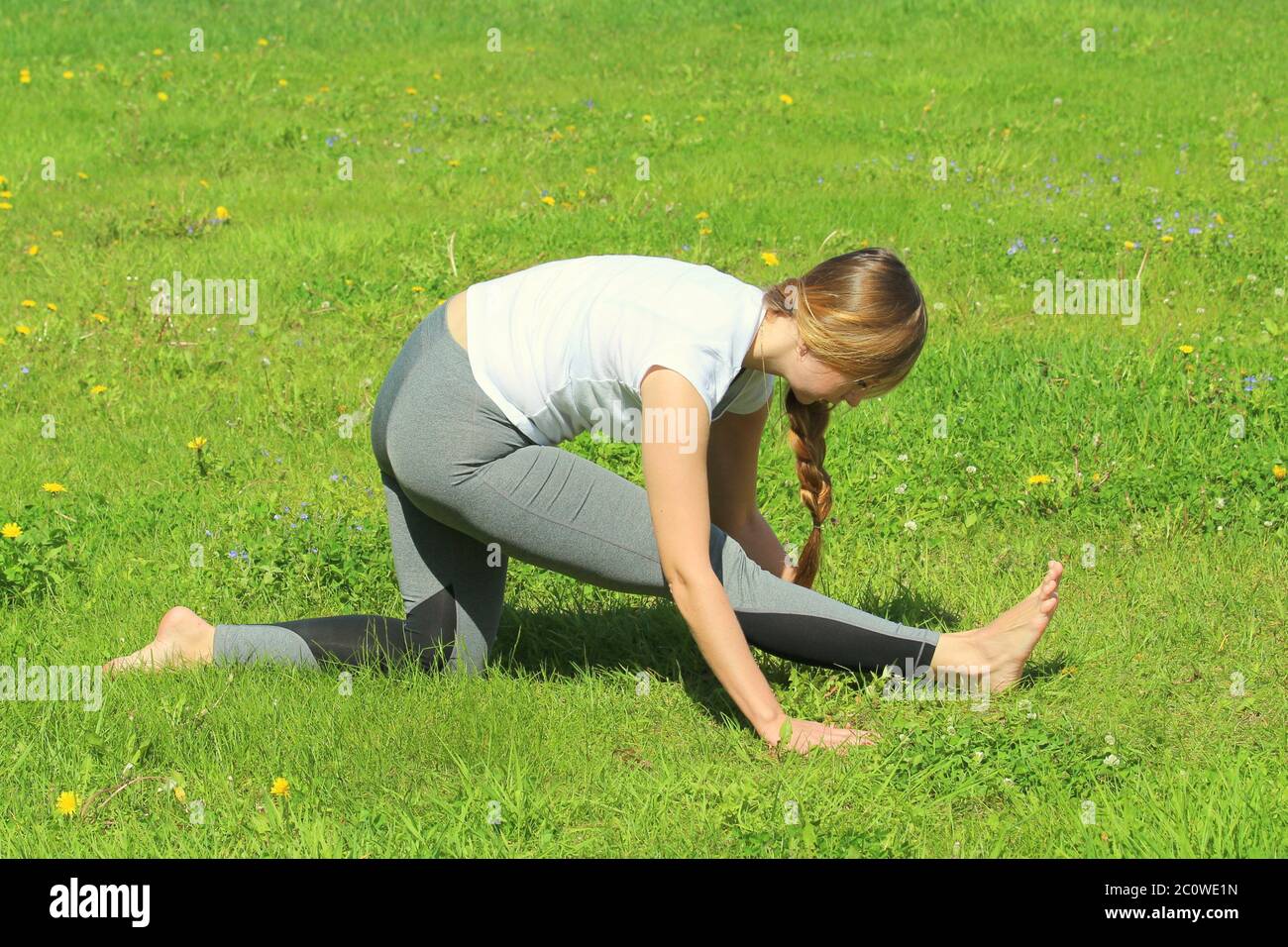 Young woman of European appearance does yoga in summer nature. Woman ...