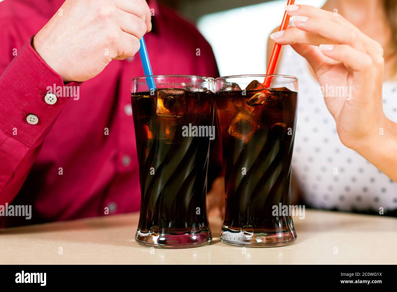 couple drinking cola in a bar or restaurant Stock Photo - Alamy
