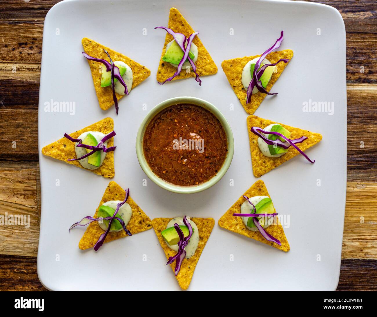 Tortilla chips with avocado and salsa Stock Photo - Alamy