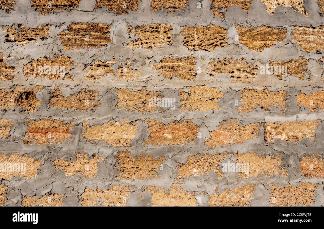 Wild stone shell rock wall texture. Uneven surface of shell rock wall ...