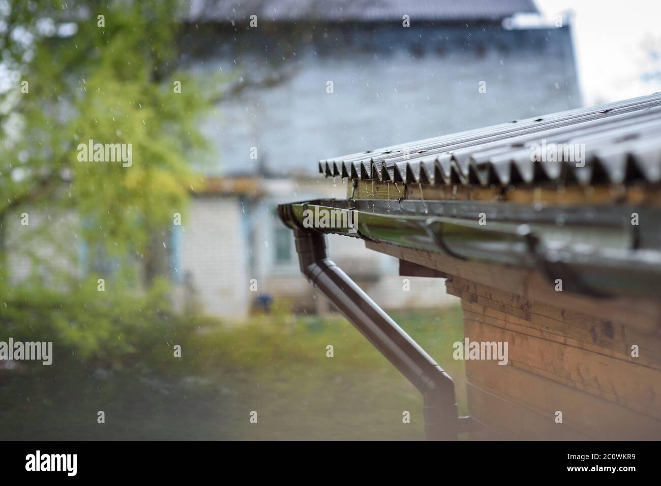 rain flows down from the roof Stock Photo - Alamy