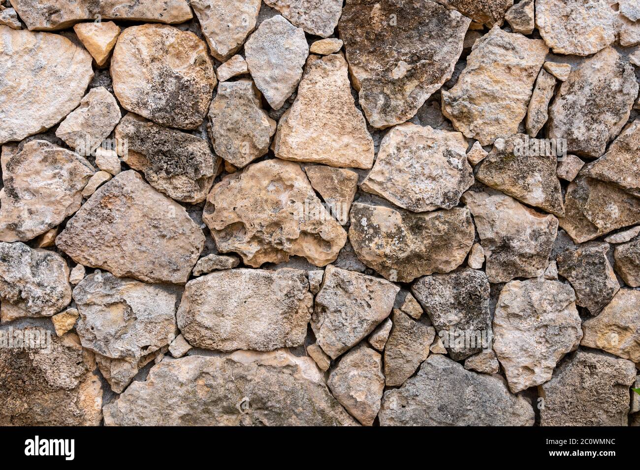 Background of limestone masonry. The surface is decorated with natural ...