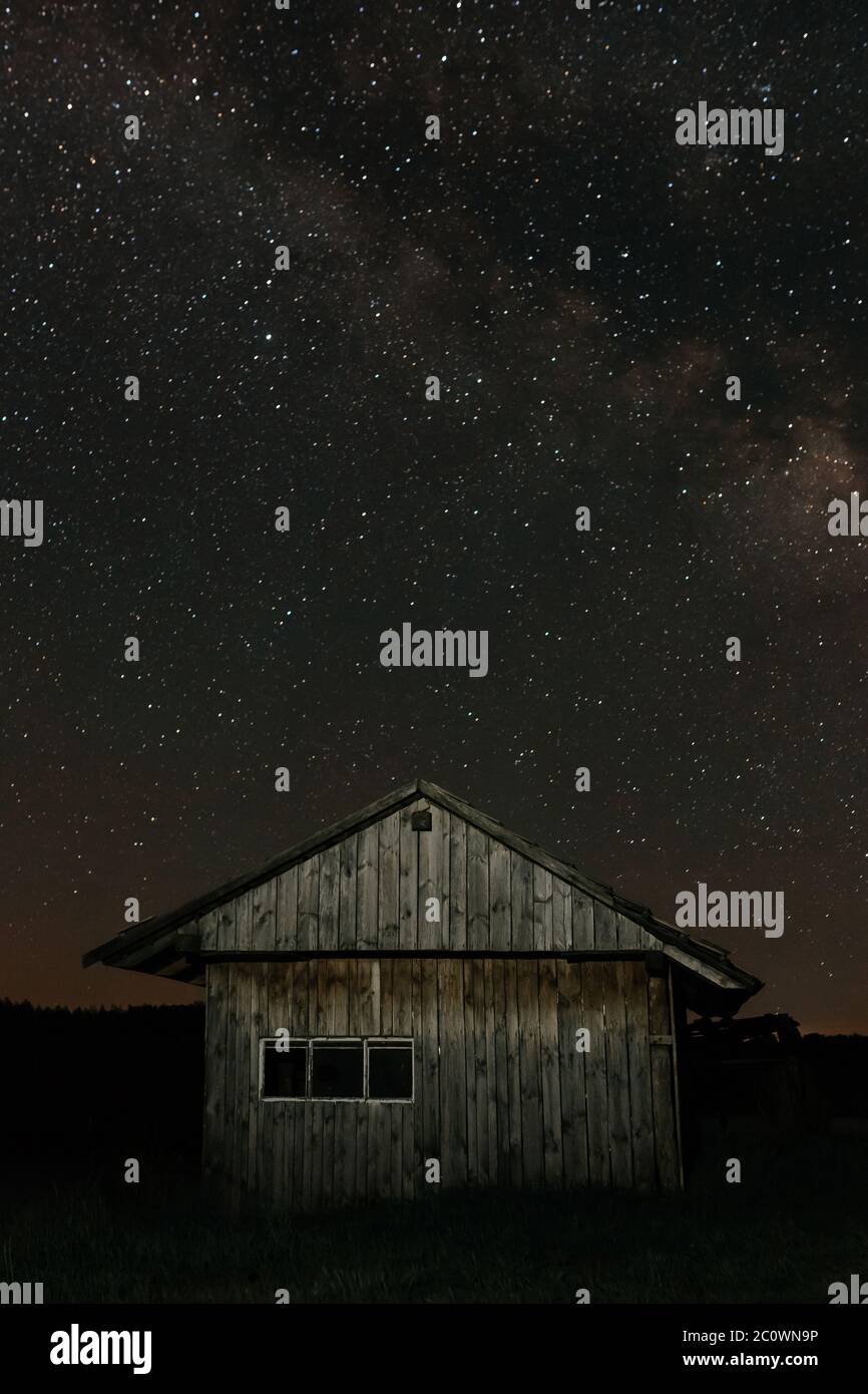 Small old wooden house on the background of the starry night. Starry ...