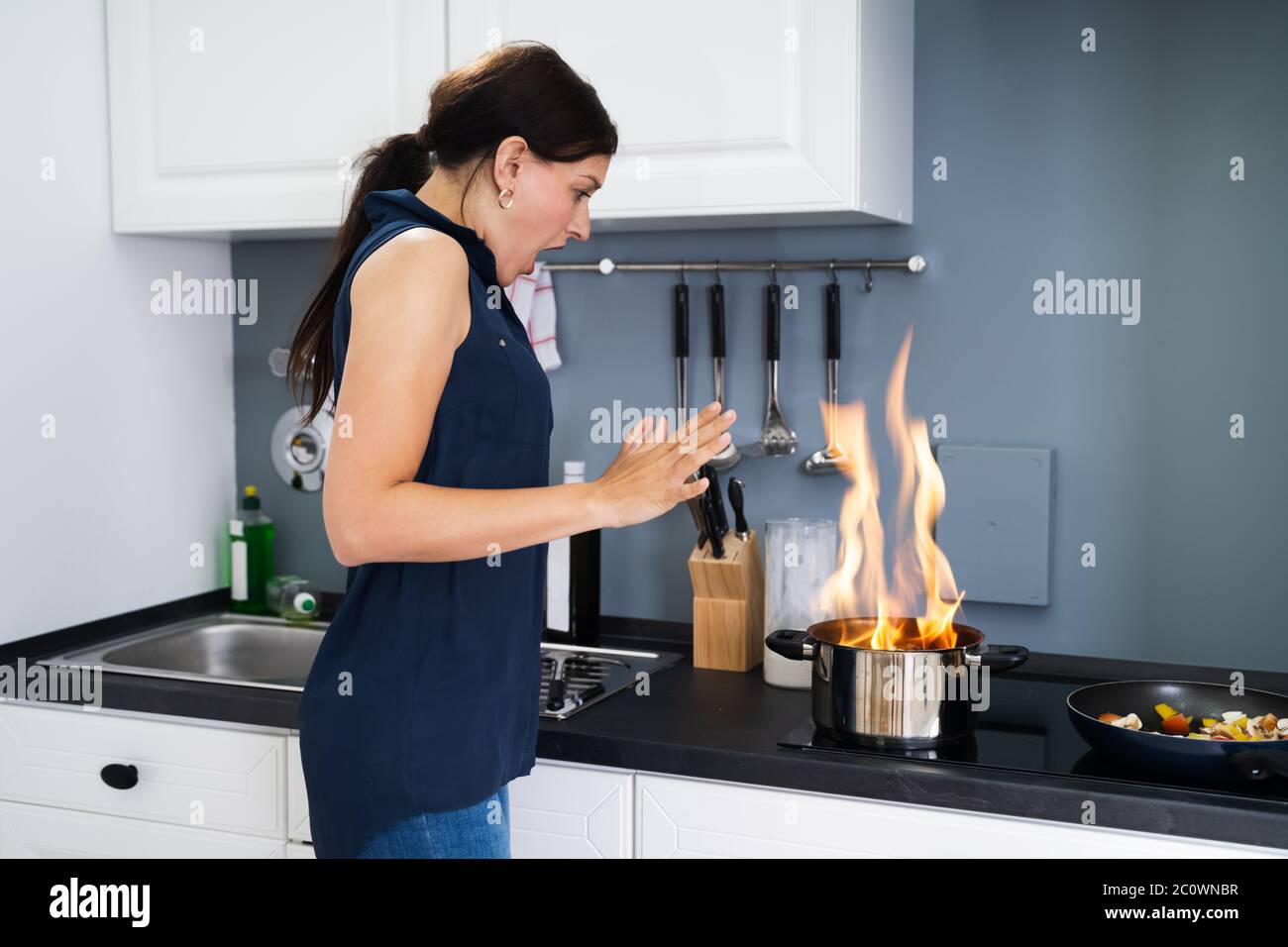 Fire In Kitchen. Pot Burning While Cooking At Home Stock Photo - Alamy