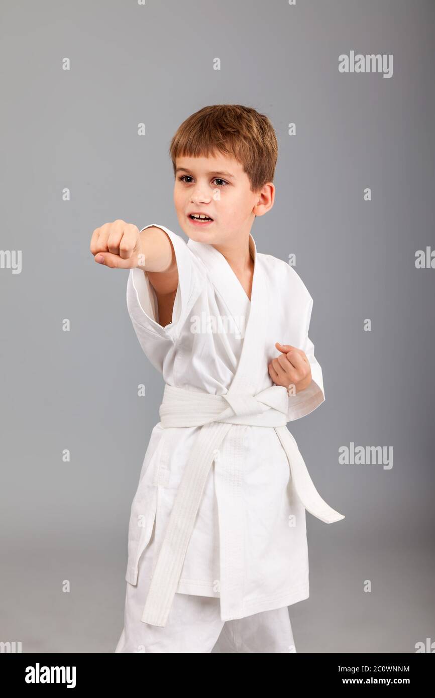Karate boy in white kimono fighting Stock Photo - Alamy