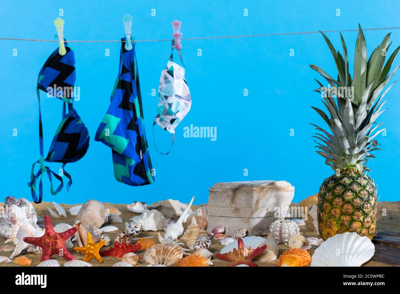 Women's swimsuit hangs on a string. Sea beach with wet sand. Ripe ...