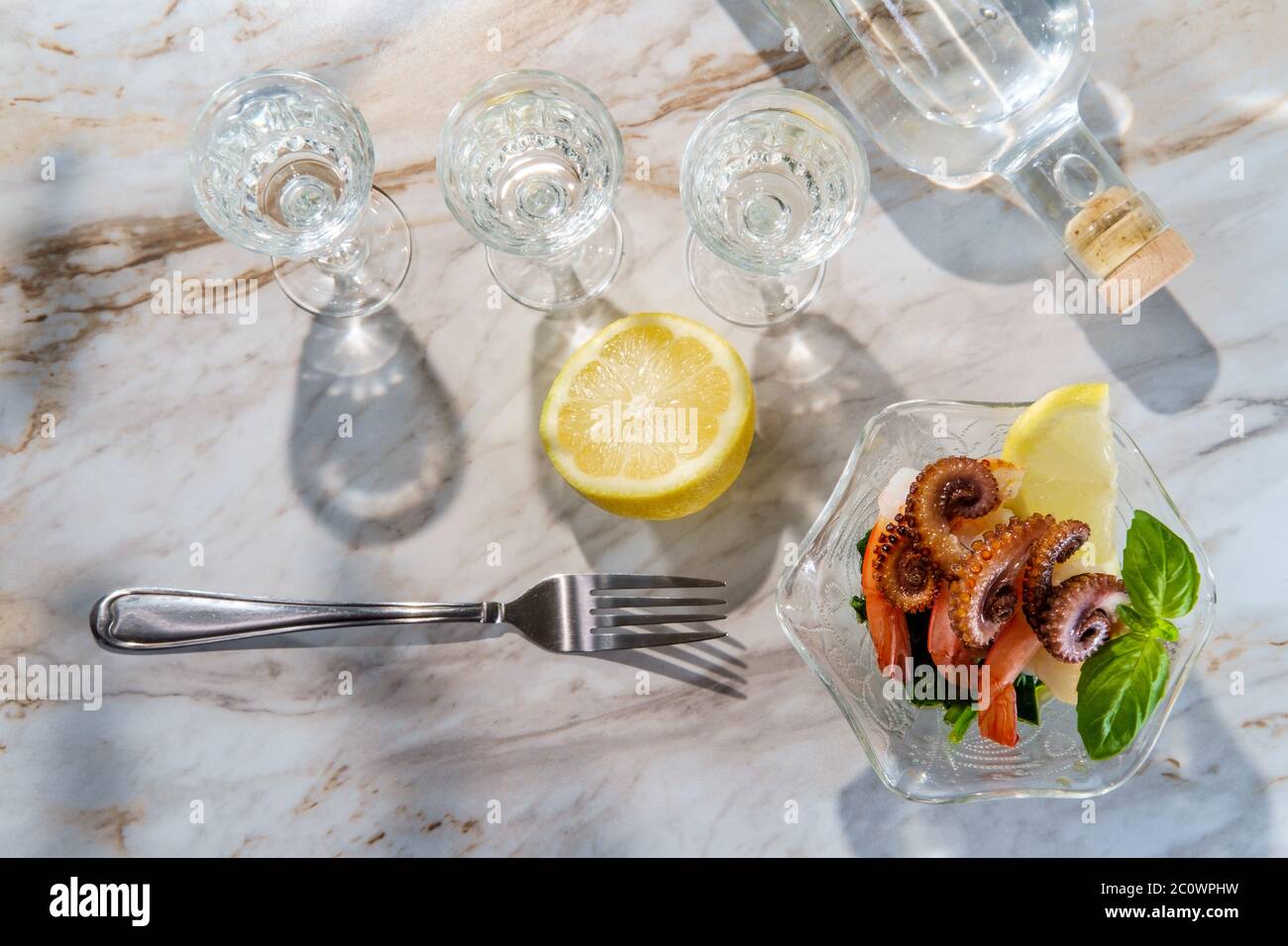 Shrimp and octopus tentacle cocktail appetizer with brunch vodka shots ...