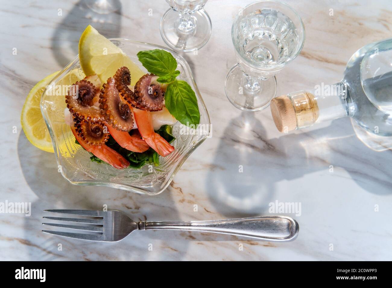 Shrimp and octopus tentacle cocktail appetizer with brunch vodka shots ...