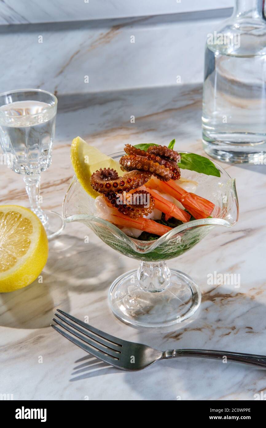 Shrimp and octopus tentacle cocktail appetizer with brunch vodka shots ...