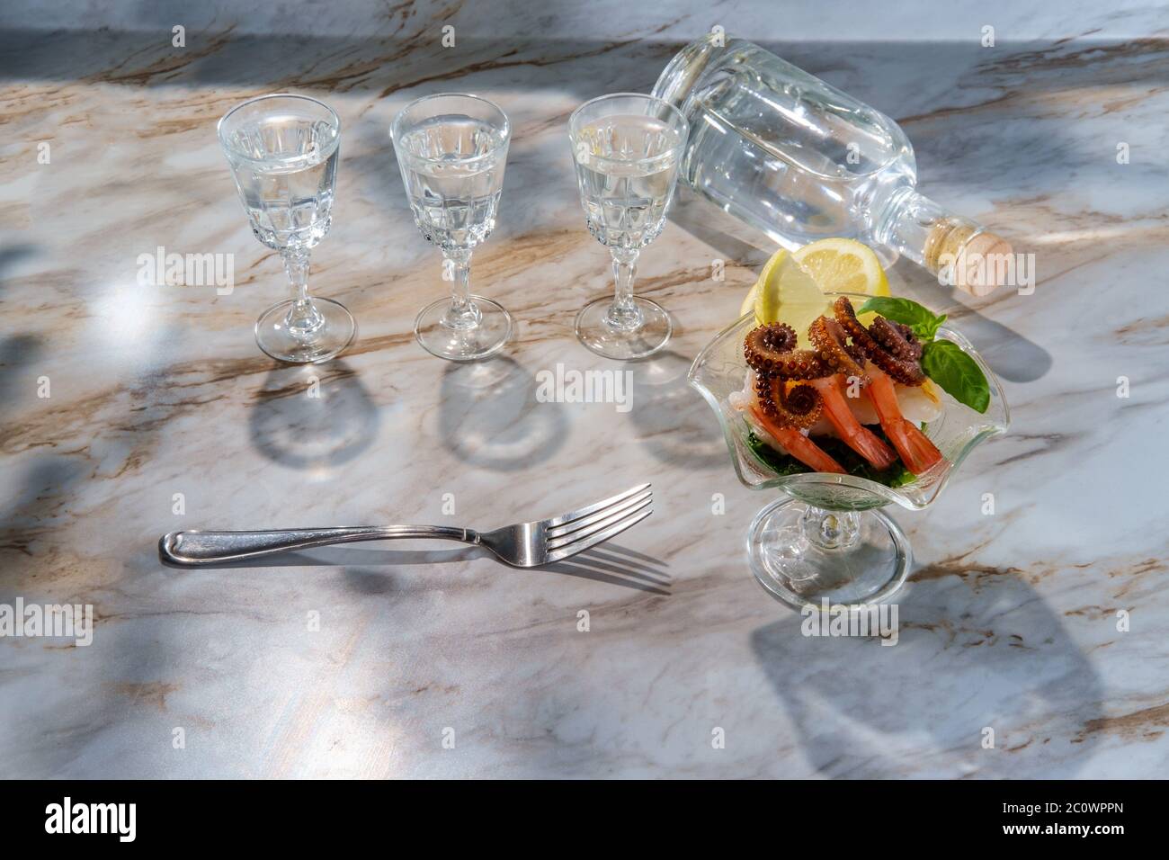 Shrimp and octopus tentacle cocktail appetizer with brunch vodka shots ...