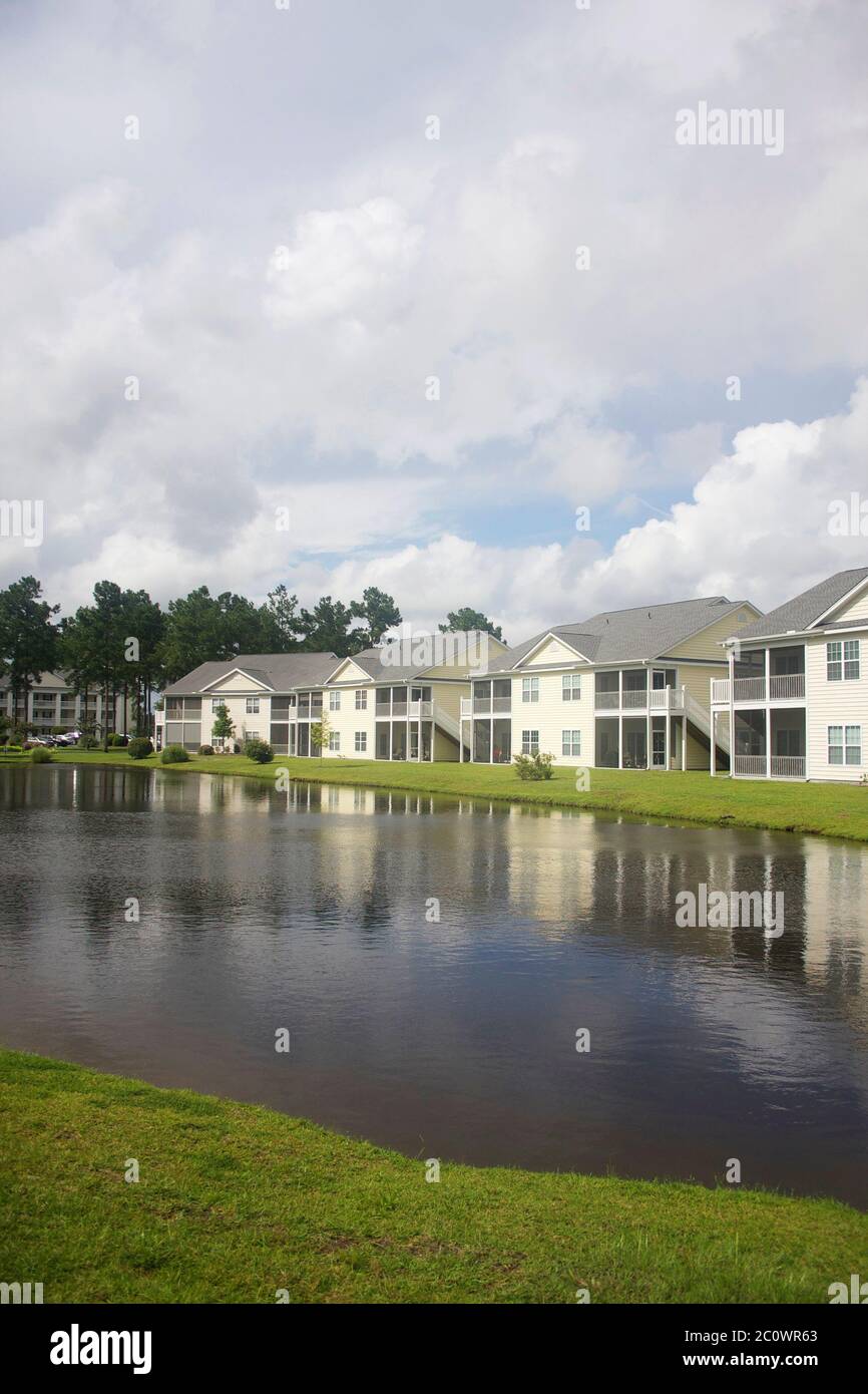 Background with a modern neighborhood with buildings around the pond ...