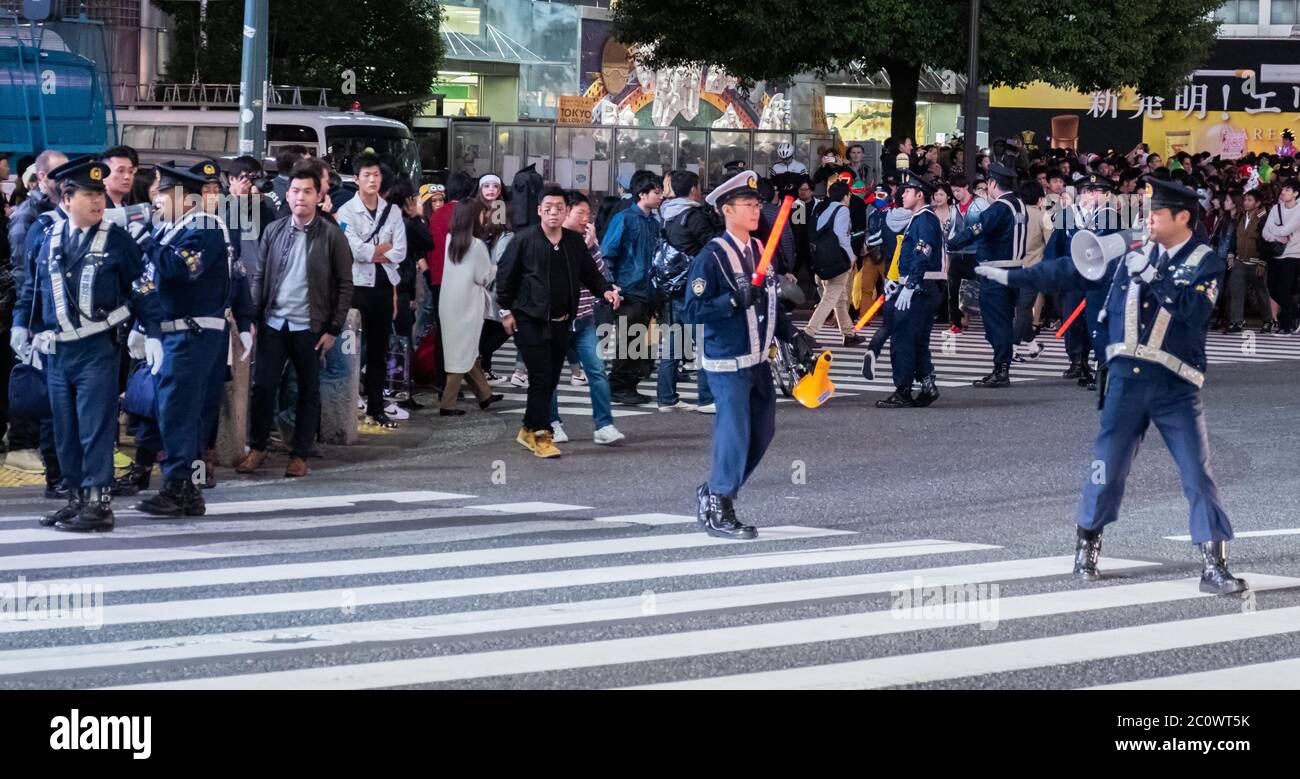 Tokyo police maintaining control and order in Shibuya during Halloween ...