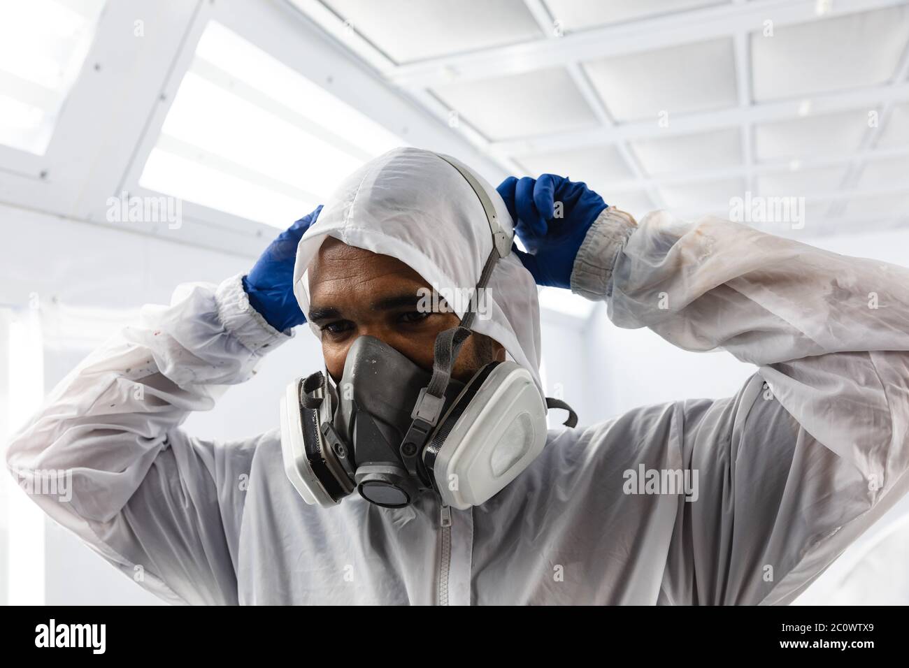 Portrait of a mixed race car painter setting mask Stock Photo - Alamy