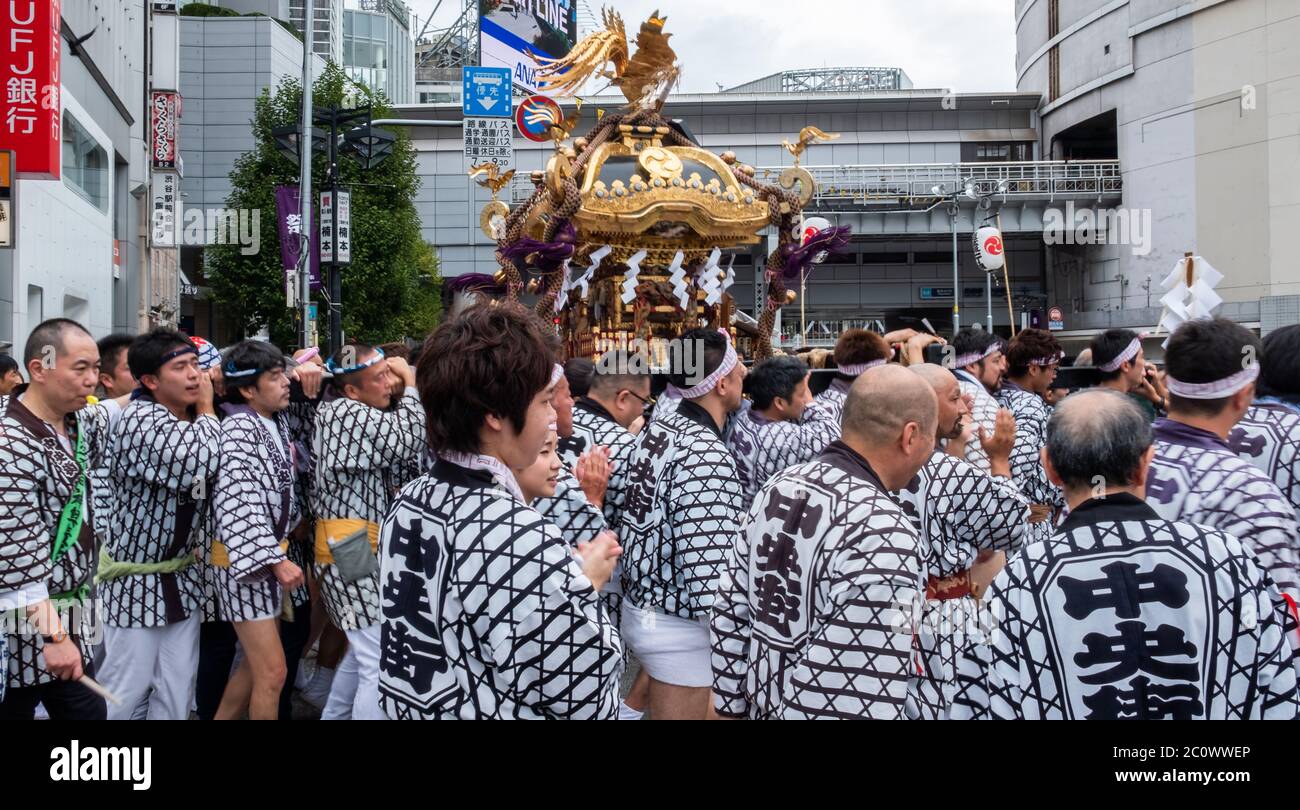 Participants of the Shibuya Mikoshi Festival parade in the street of ...