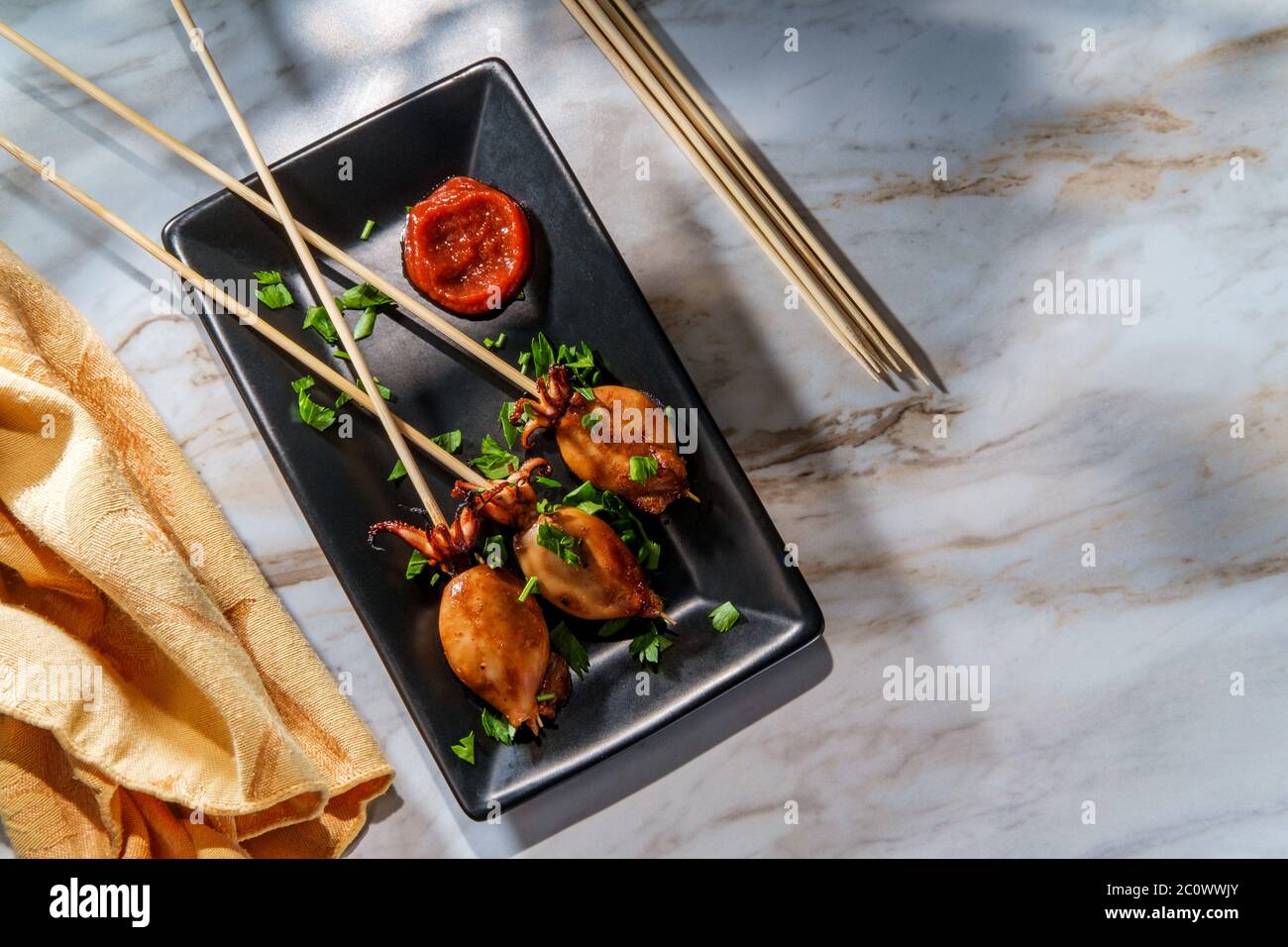 Seafood grilled squid satay kebab skewers with tentacles and sriracha ...