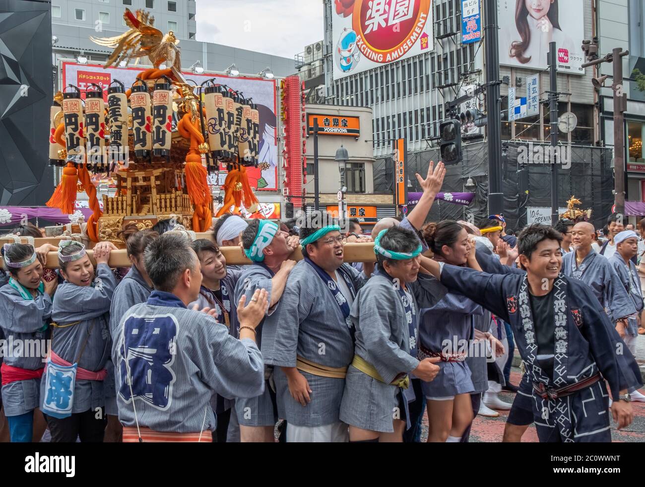 Participants of the Shibuya Mikoshi Festival parade in the street of ...