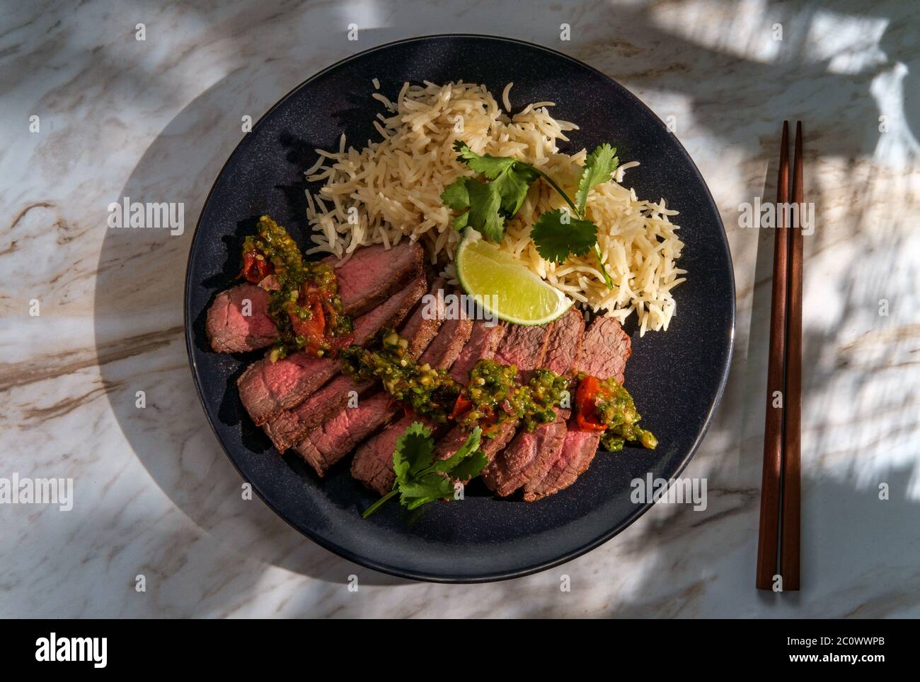 Rib-eye steak cooked rare with hot and spicy Thai crying tiger sauce ...