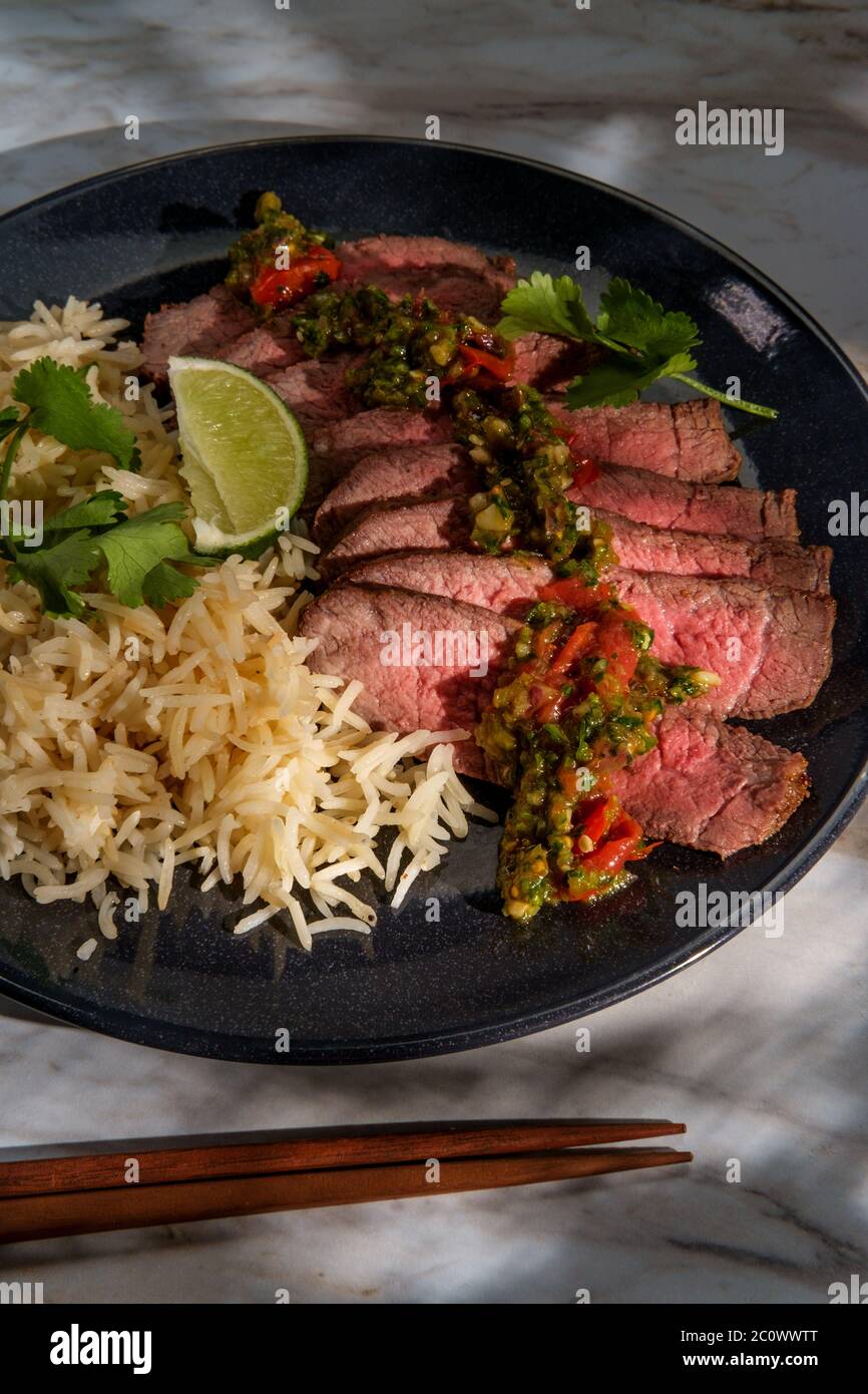 Rib-eye steak cooked rare with hot and spicy Thai crying tiger sauce ...