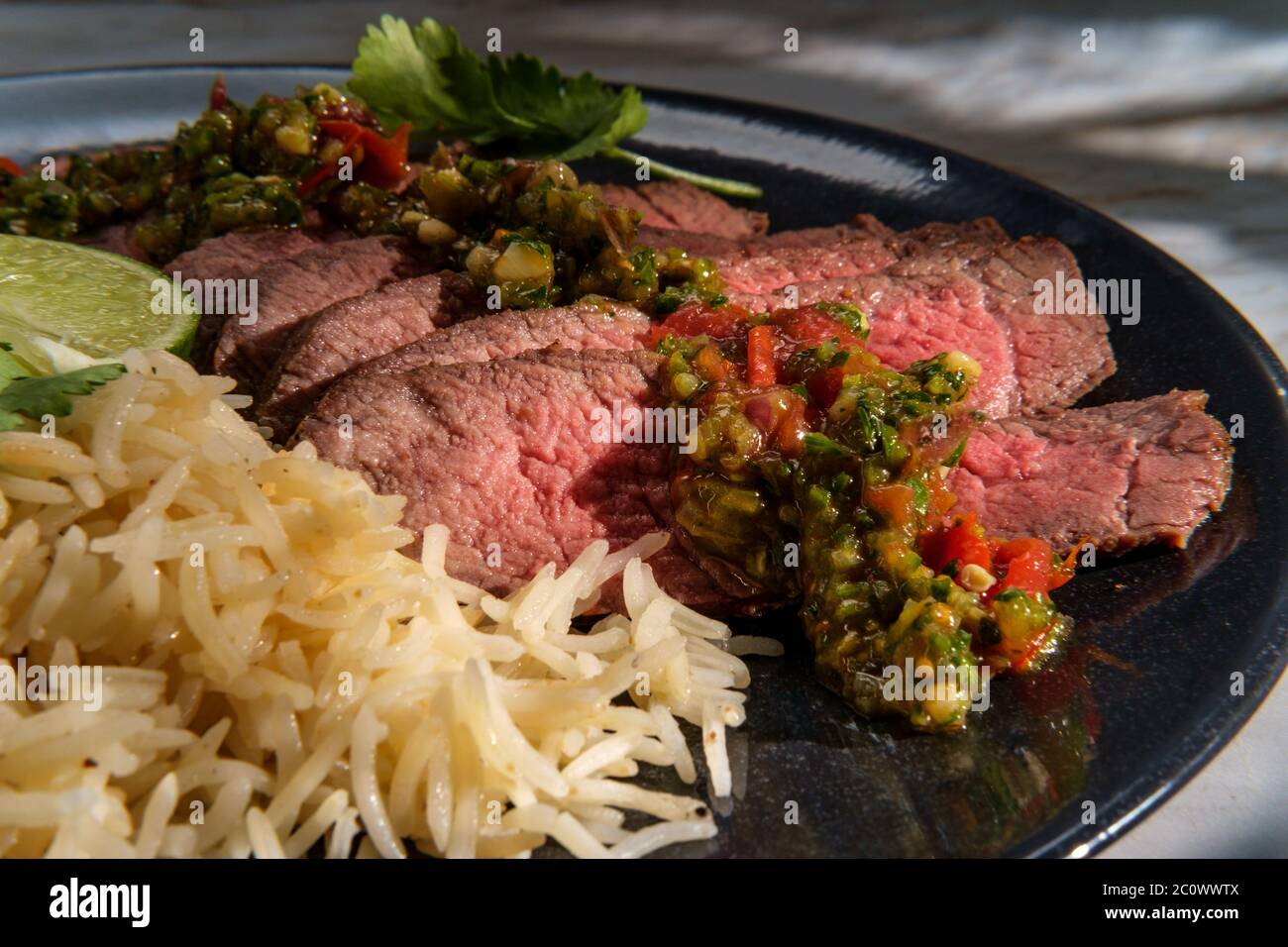 Rib-eye steak cooked rare with hot and spicy Thai crying tiger sauce ...