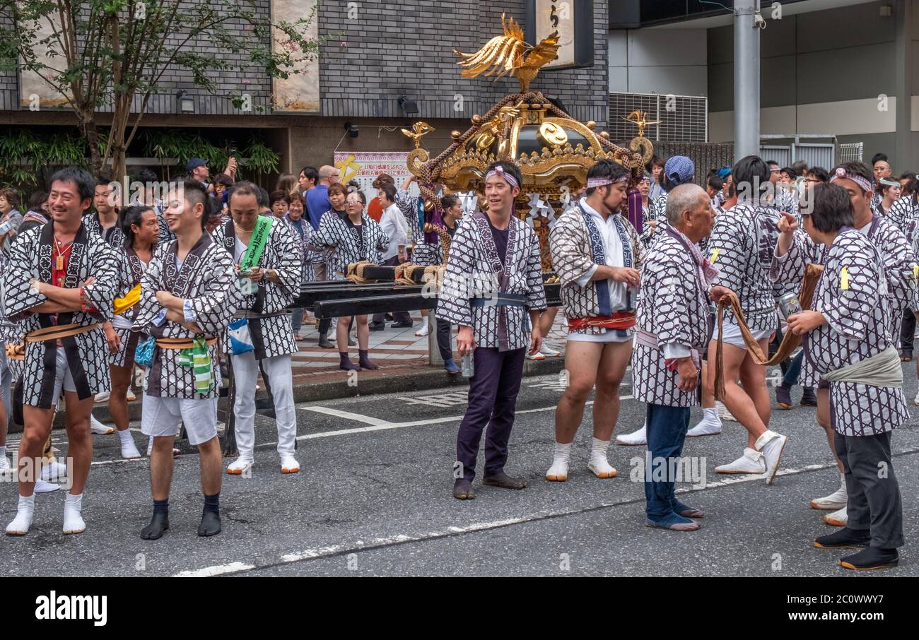 Participants of the Shibuya Mikoshi Festival parade in the street of ...