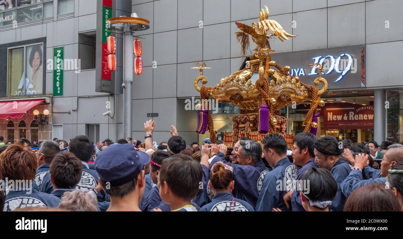 Participants of the Shibuya Mikoshi Festival parade in the street of ...
