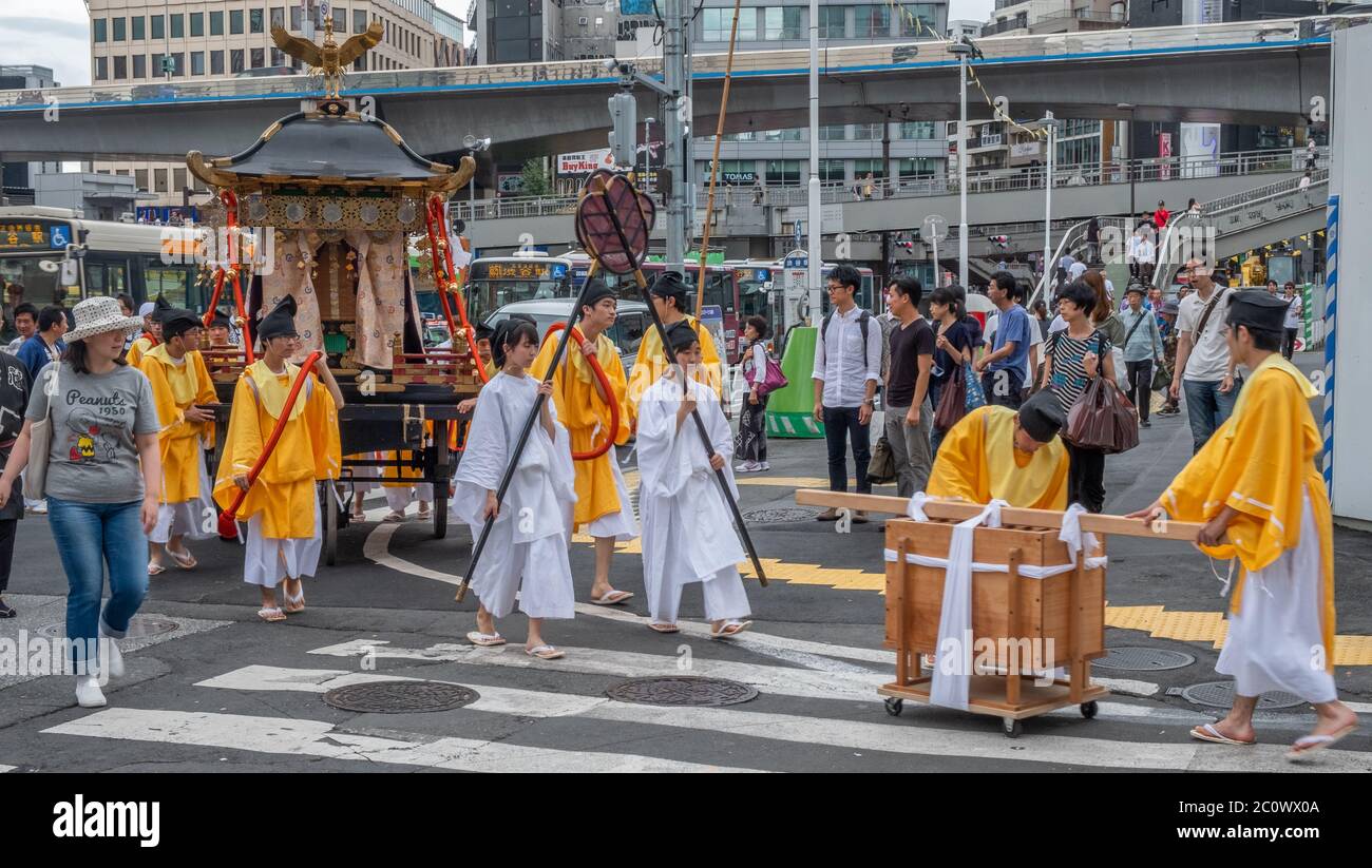 Participants of the Shibuya Mikoshi Festival parade in the street of ...