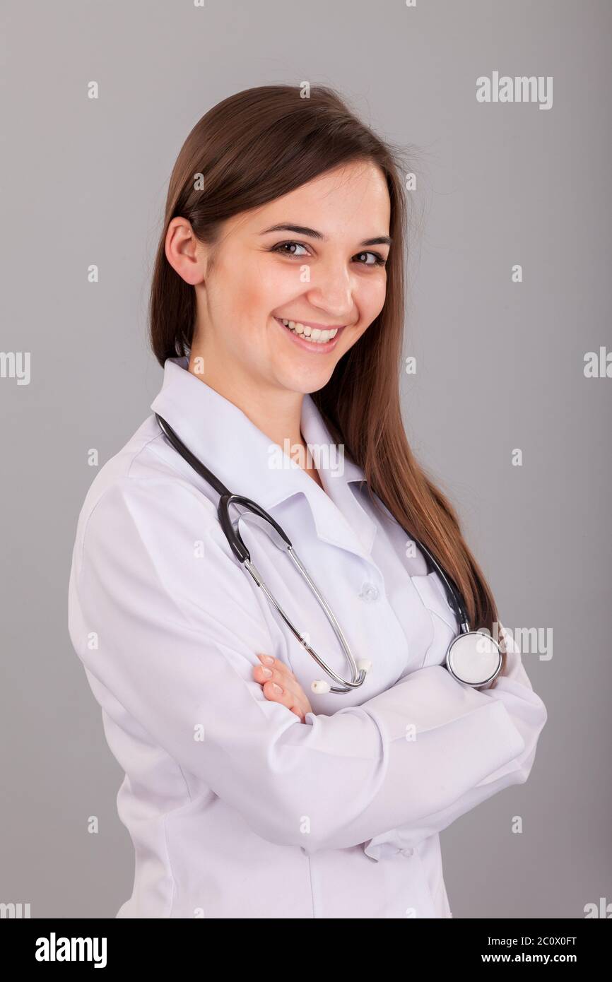 Young beautiful nurse on grey hi-res stock photography and images - Alamy