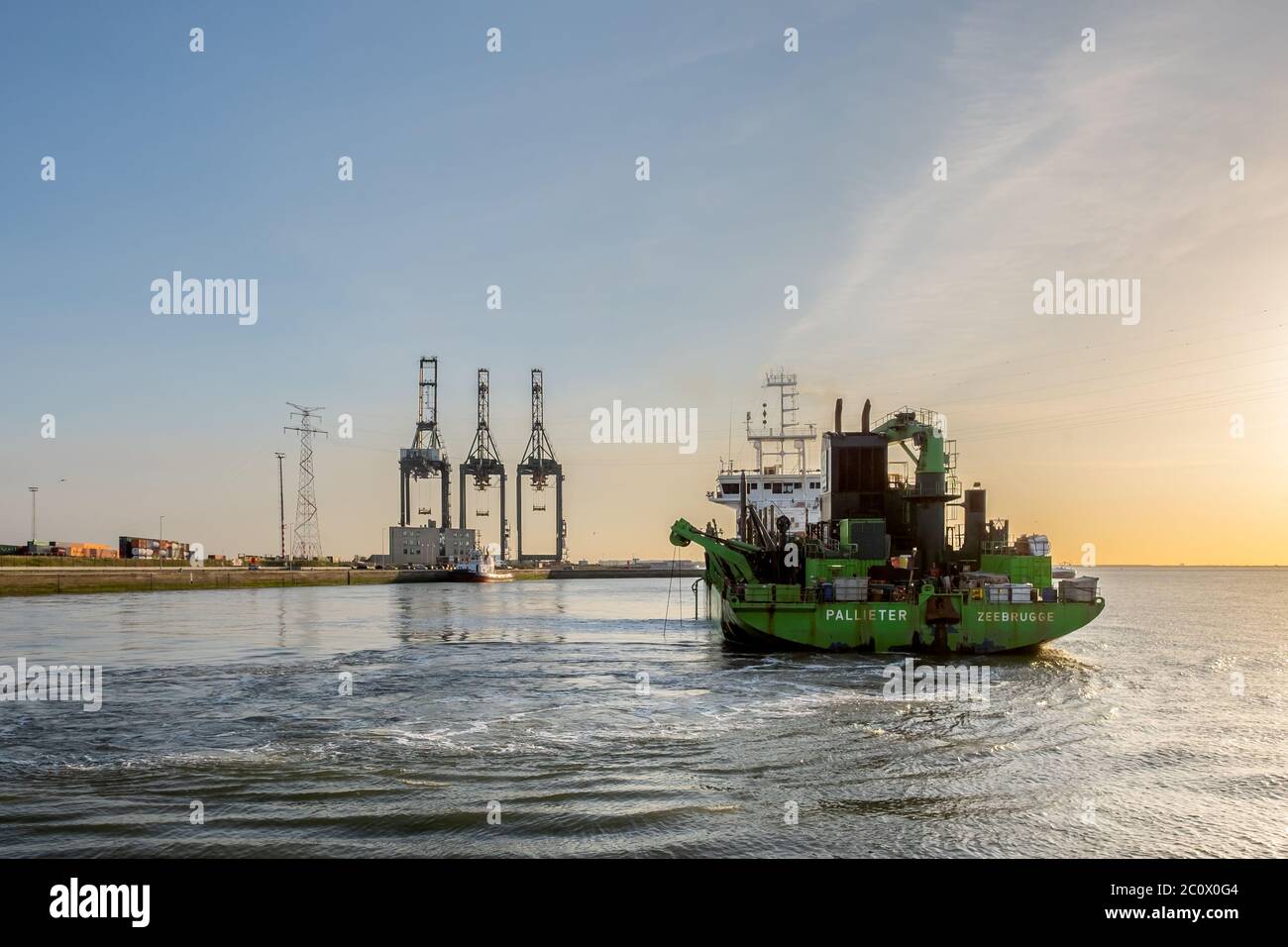 The hopper dredger vessel Pallieter sailing past the PSA Antwerp Europe ...