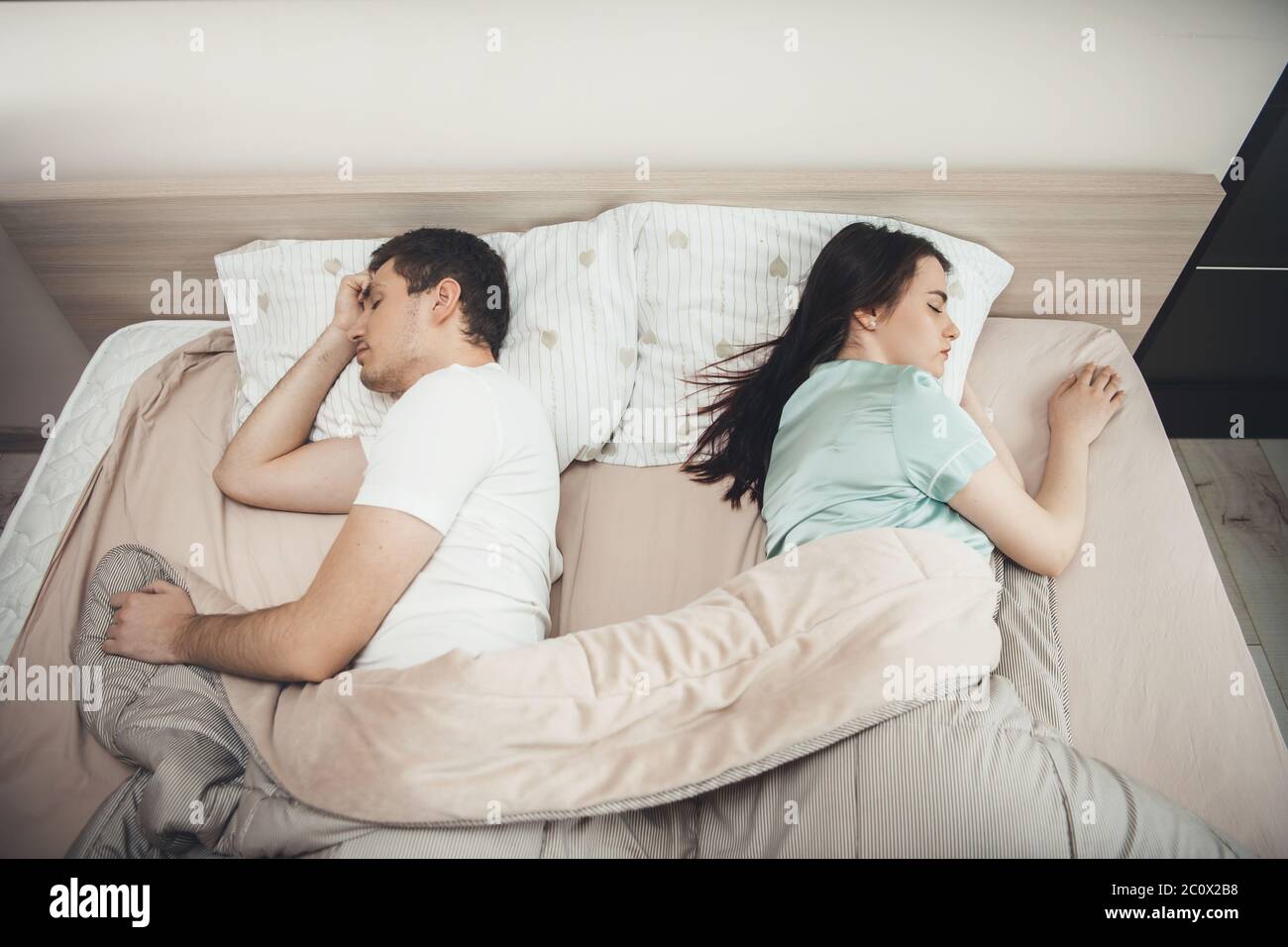 Upper view photo of a caucasian couple sleeping apart in their bed ...