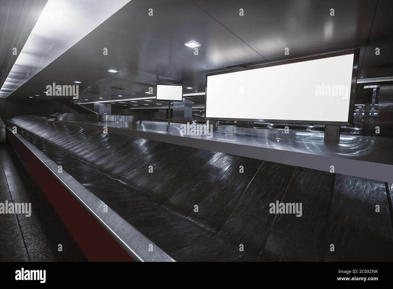 Wide-angle view of a baggage claim area in a hall of a modern airport ...