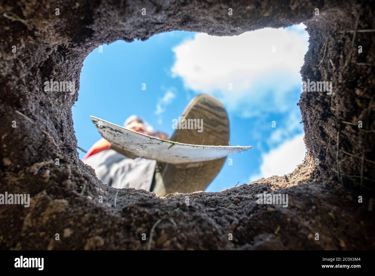 Foot digging an earth in the garden with an old spade, close up Stock ...