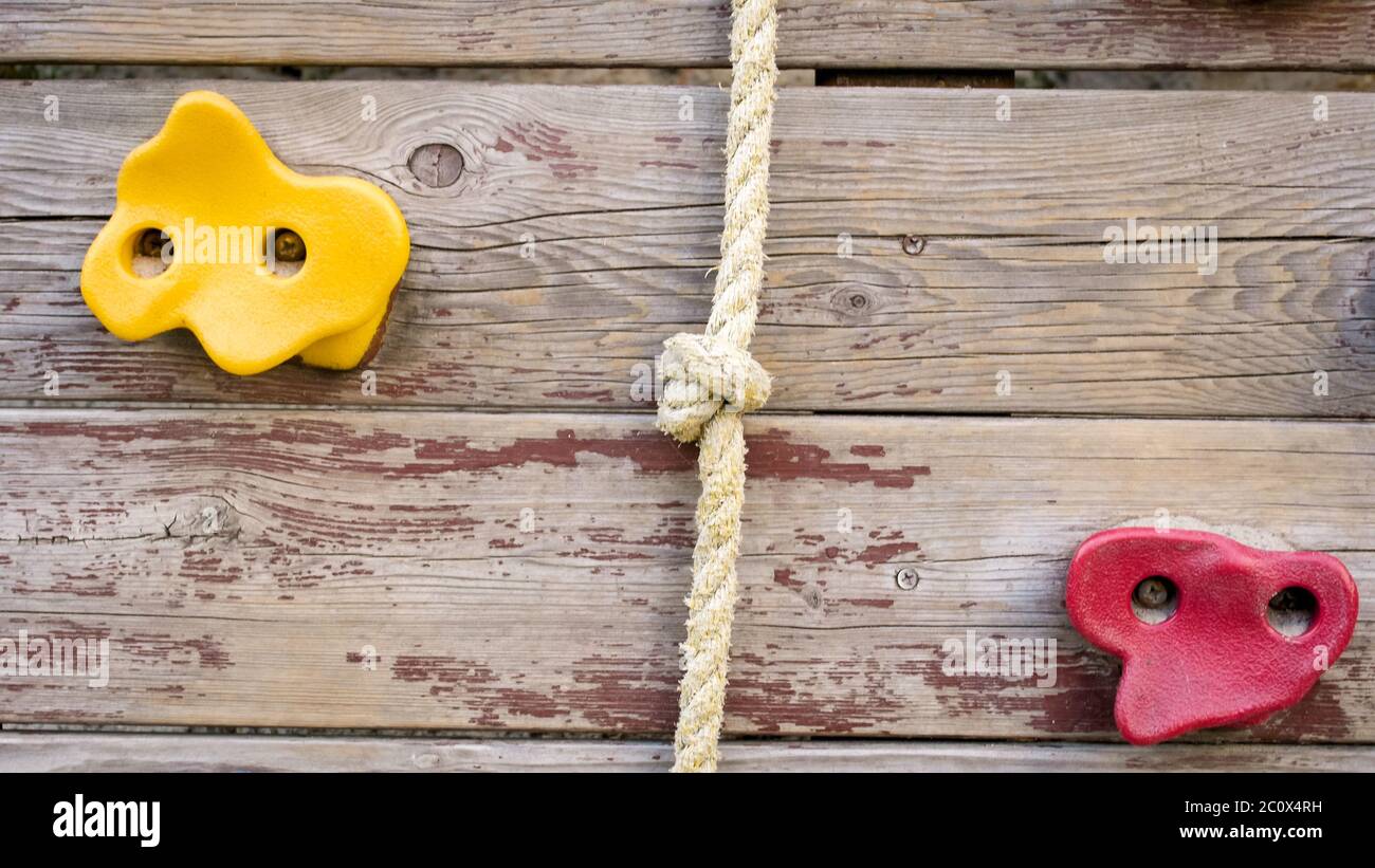 Colorful plastic grips and ropes on wall at cliff climbing center Stock ...
