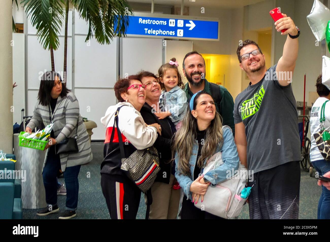 Arriving passengers at Orlando International Airport in Florida pose ...
