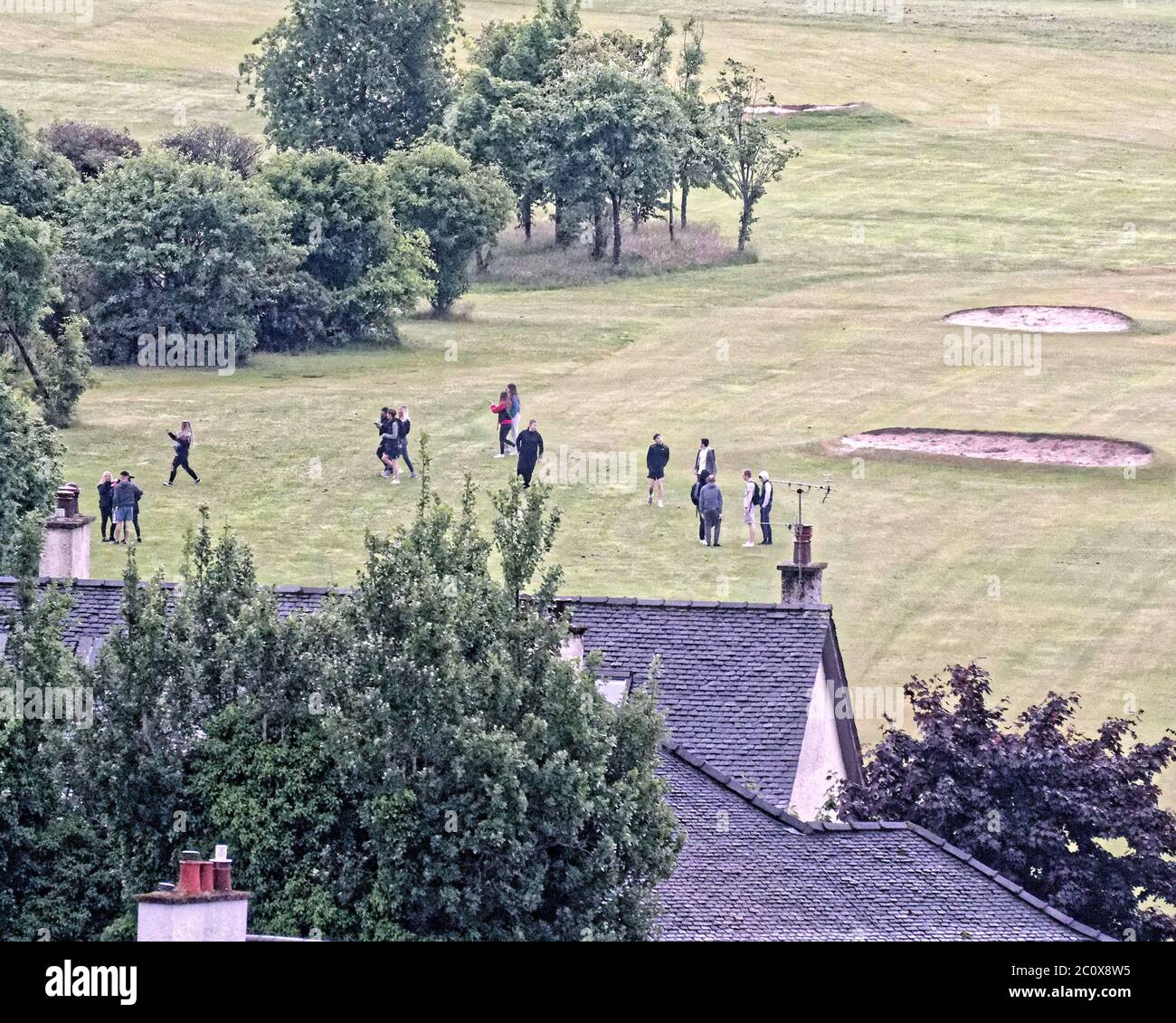 Glasgow, Scotland, UK 12th June, 2020: Teenage children having a late ...