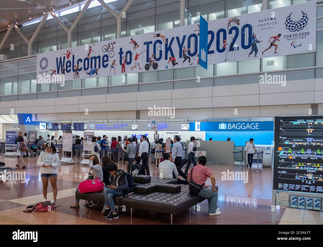 Passengers at the Haneda International Airport departure terminal ...