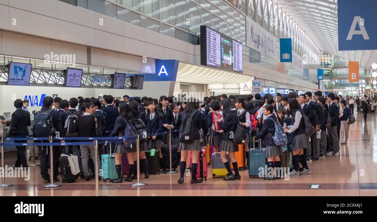 Passengers at the Haneda International Airport departure terminal ...