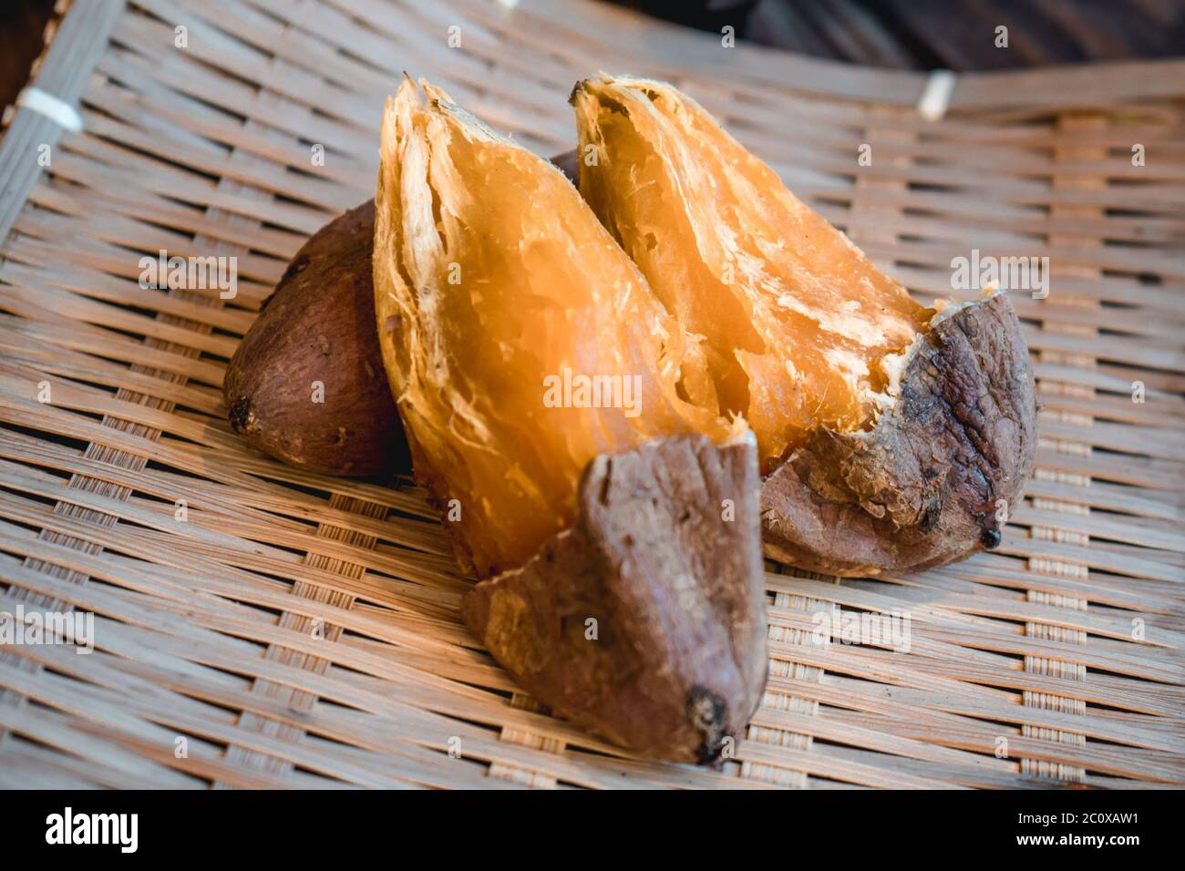 Baked Japanese sweet yellow potatoes in a basket Stock Photo - Alamy