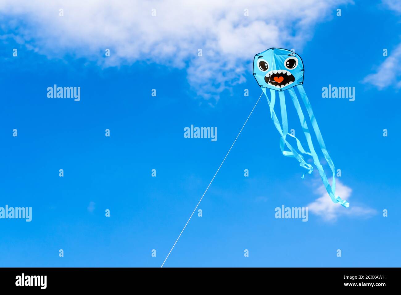 smiling kite flying in the blue sky Stock Photo - Alamy