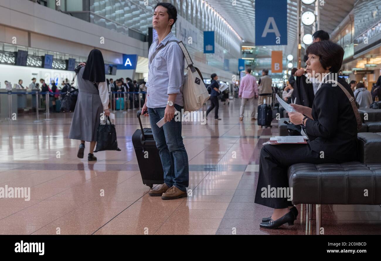 Passengers at the departure terminal of Haneda International Airport ...
