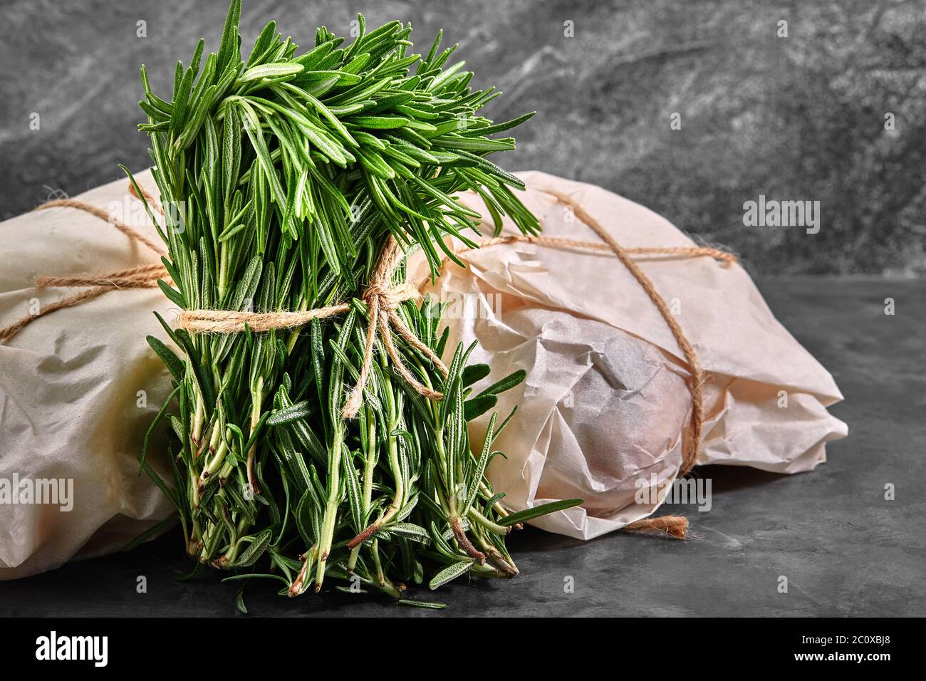 Organic bouquet of fresh rosemary on a gray background. A beautifully ...