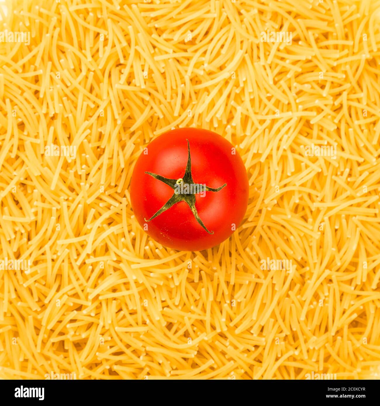 Pasta texture background with tomato Stock Photo - Alamy