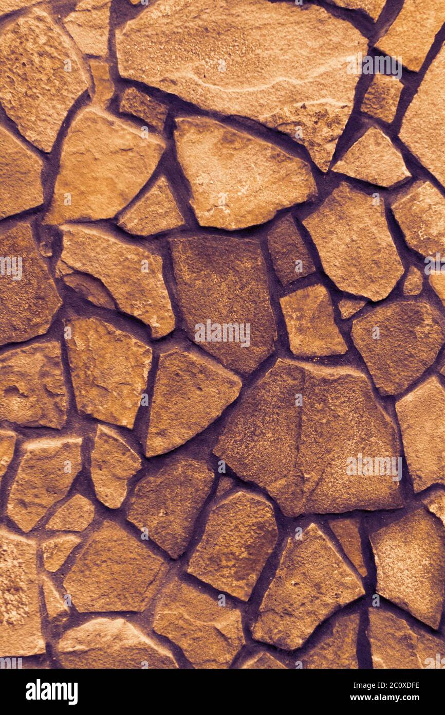 Close up photo of an orange stone wall Stock Photo - Alamy