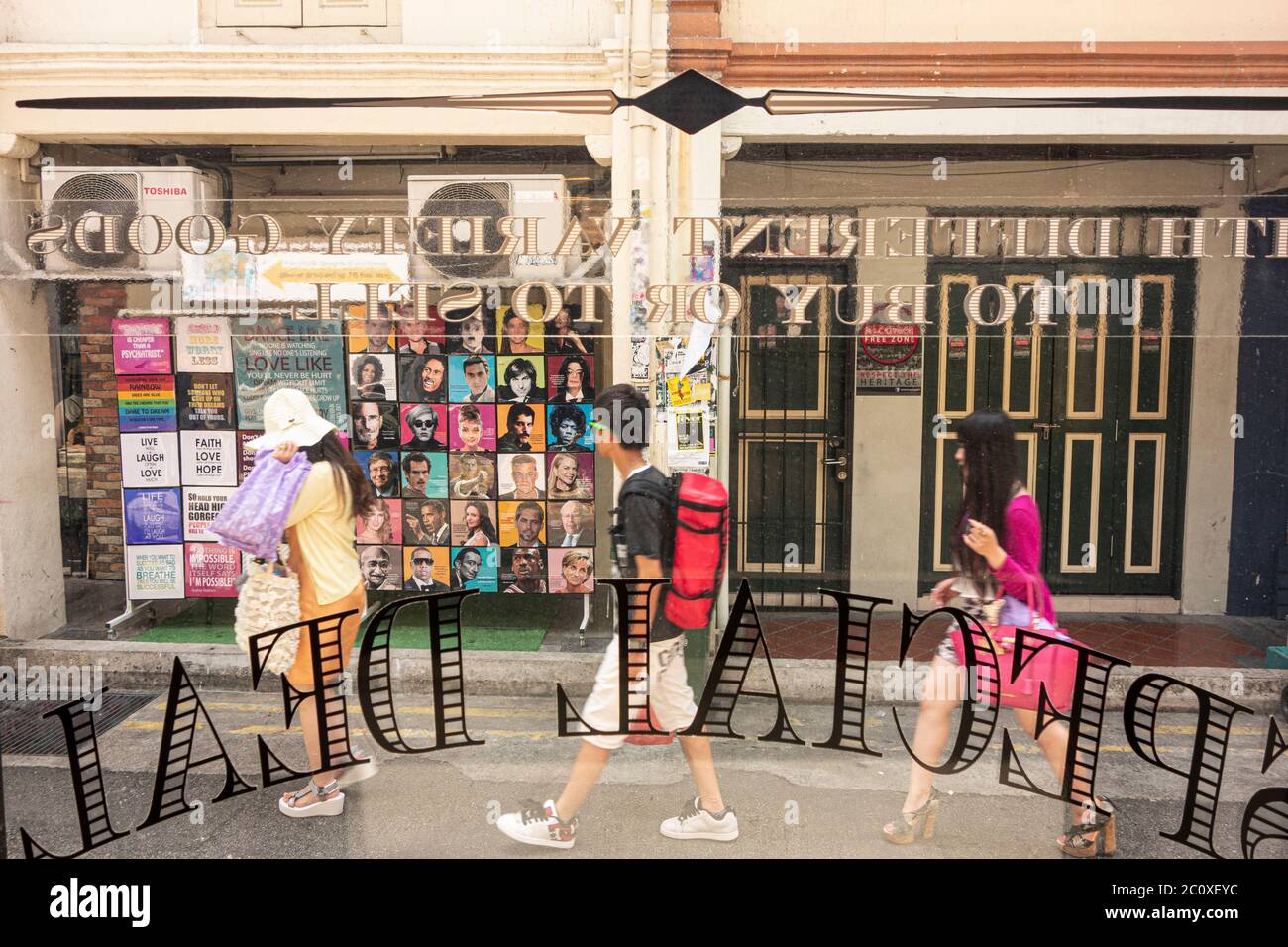 Street scenes trough the shop window of a box rental store. Haji Lane ...