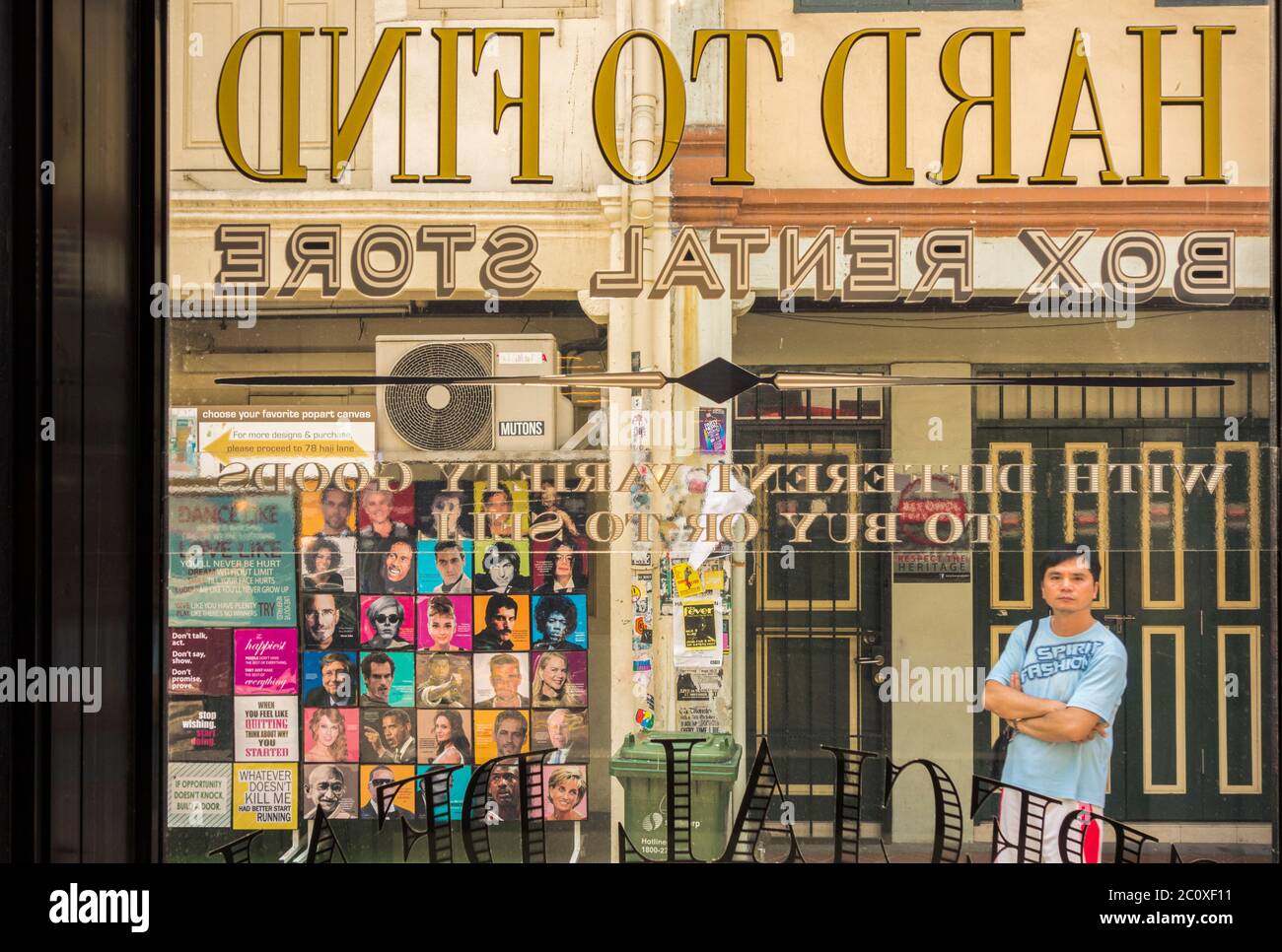 Street scenes trough the shop window of a box rental store. Haji Lane ...