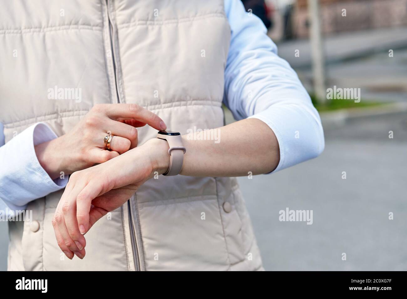 Girl uses a smart watch on her hand while walking down the street Stock ...