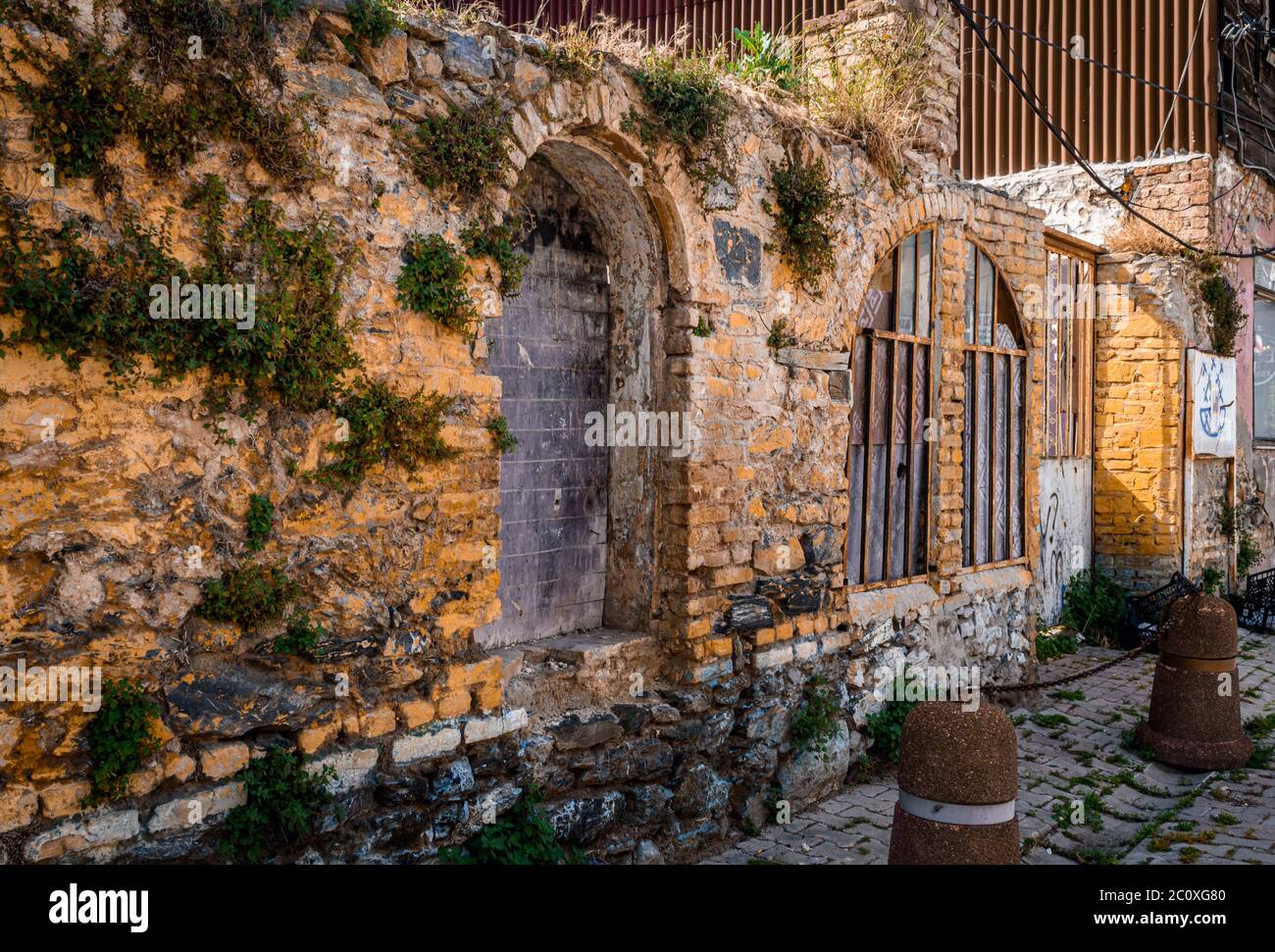 side wall of an elegant old building with old style windows and doors ...