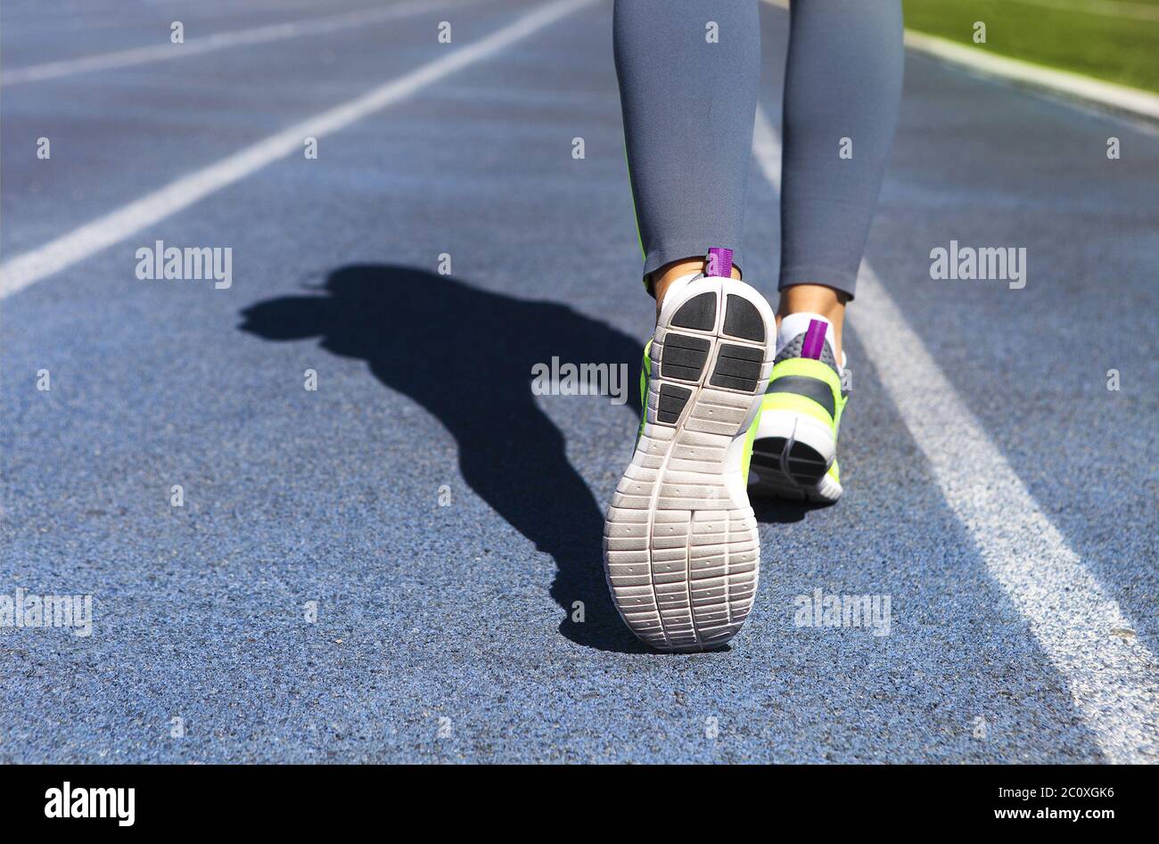 Athlete runner feet down stadium track. Jogging, sport, healthy active ...