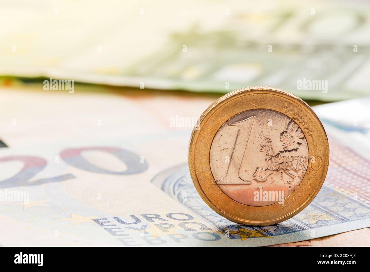 One euro coin on euro notes background Stock Photo - Alamy