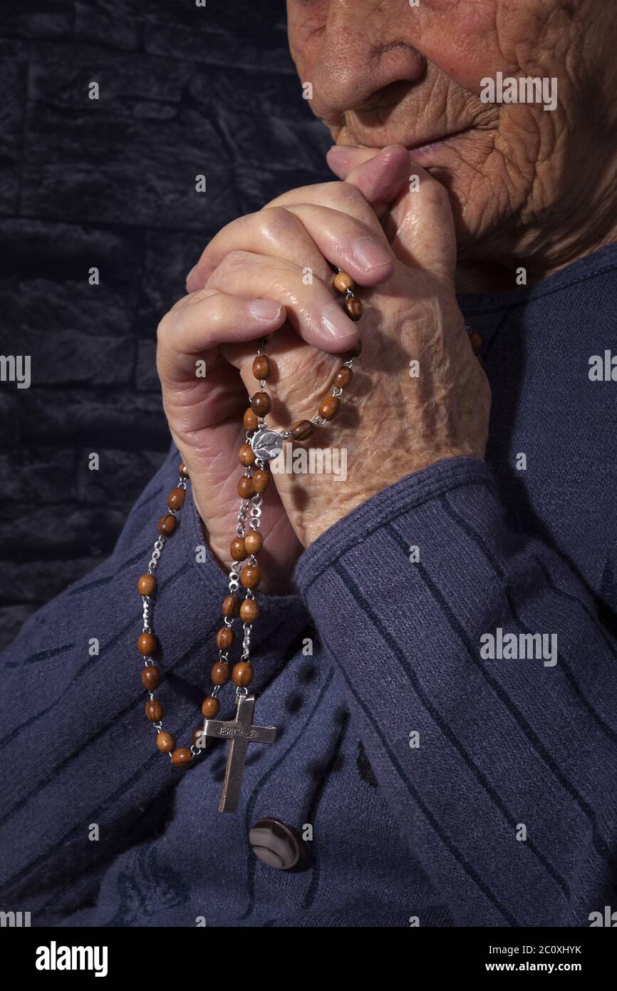 Senior woman praying rosary hi-res stock photography and images - Alamy