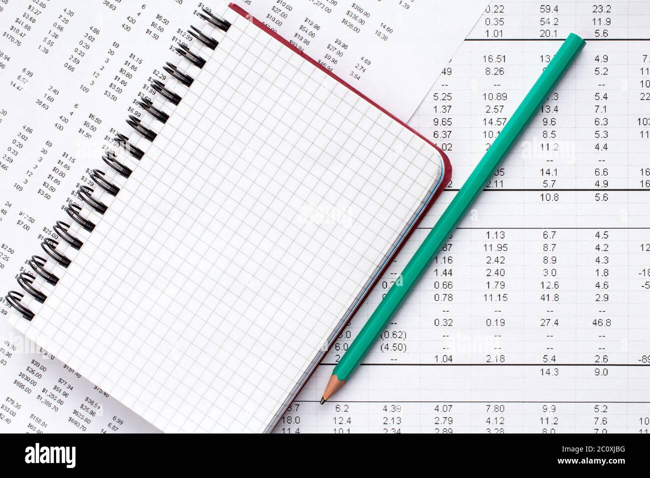 Pencil and notebook on financial chart Stock Photo - Alamy